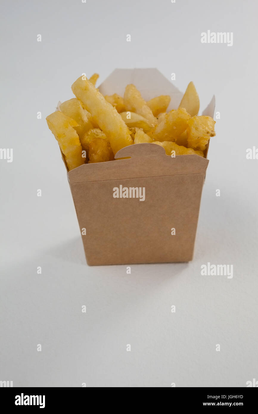 Close-up of french fried chips in a take away container on table Stock ...