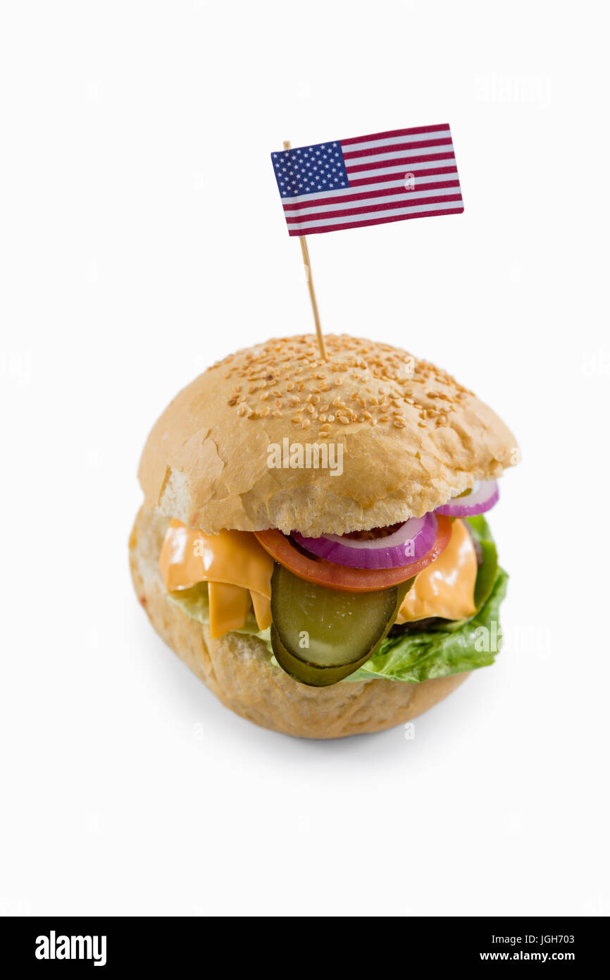 High angle view of cheeseburger with American flag on white background ...