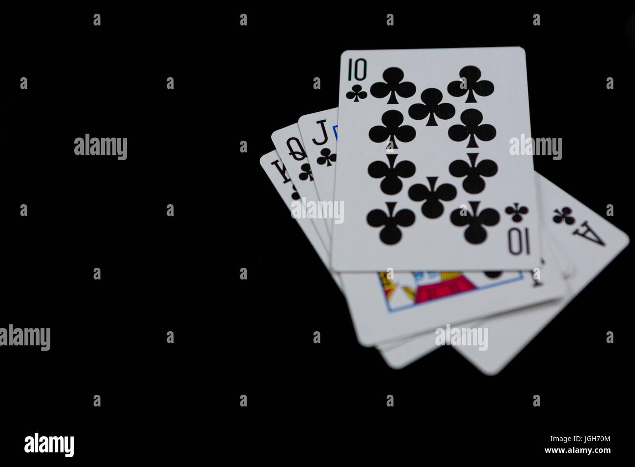 High angle view of clubs cards on black background Stock Photo - Alamy
