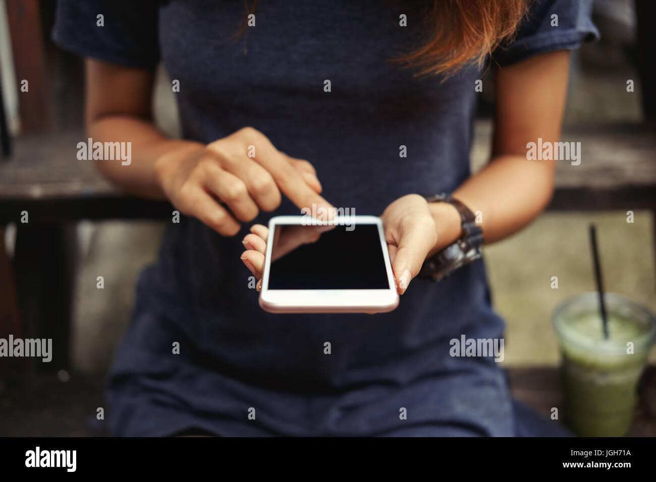 Close-up image of young hipster girl using modern smartphone device ...