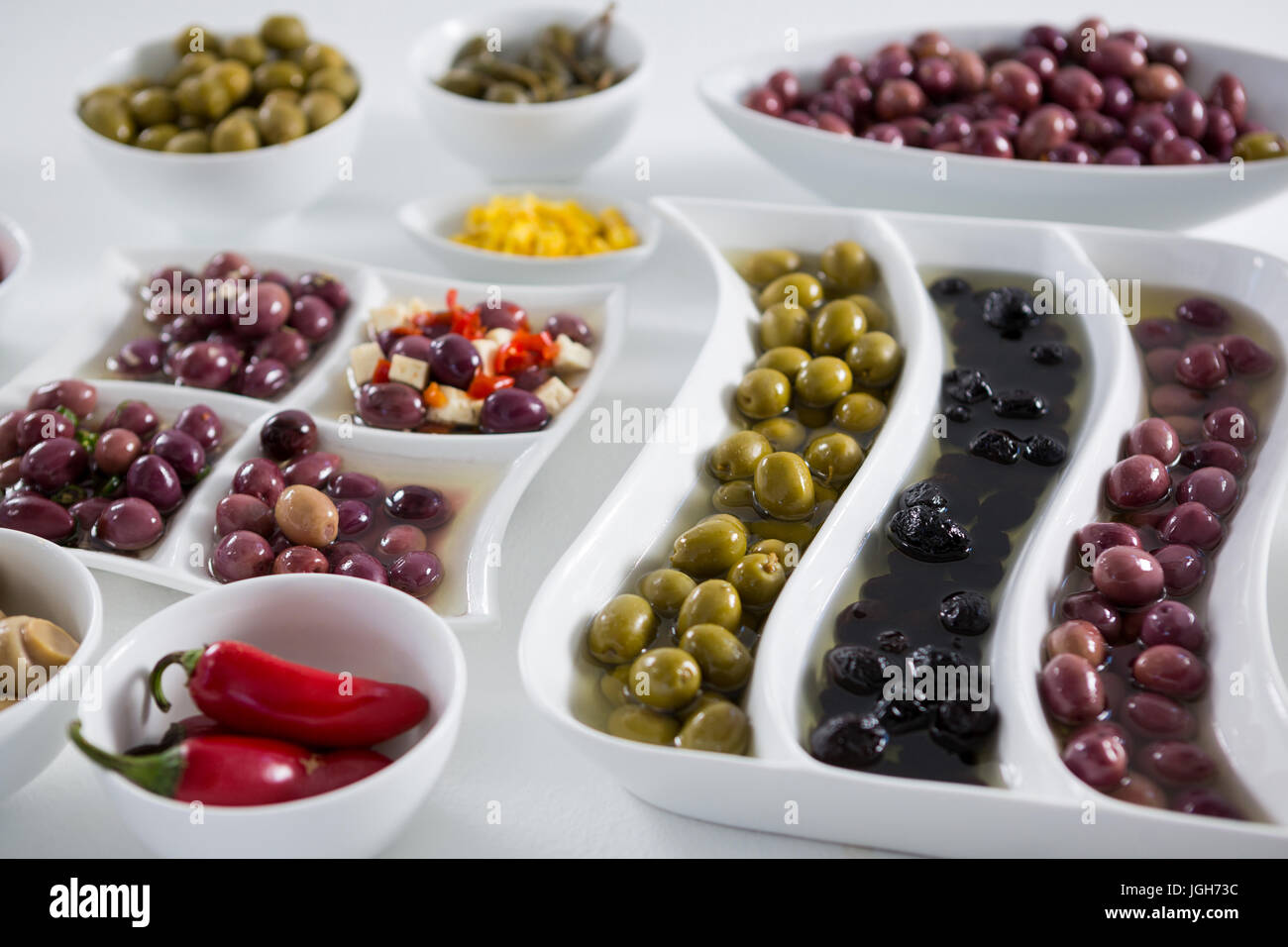 Close-up of marinated olives and vegetables on white background Stock ...