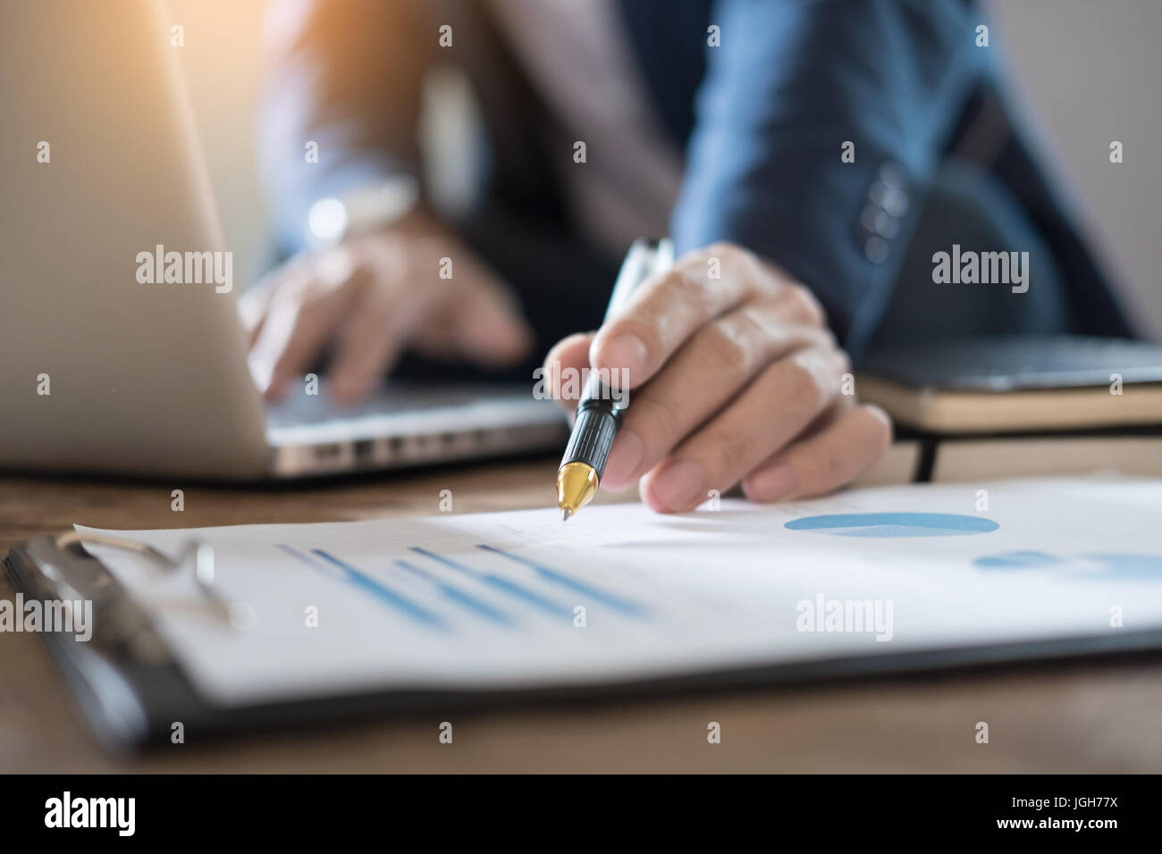 Business Man Studying accountant working with financial data Graph ...