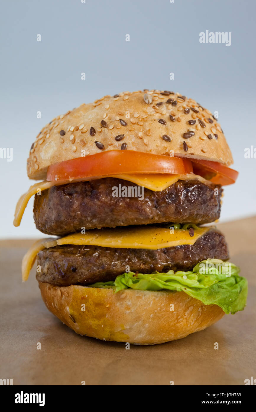 Close-up of hamburger on brown paper against white background Stock ...