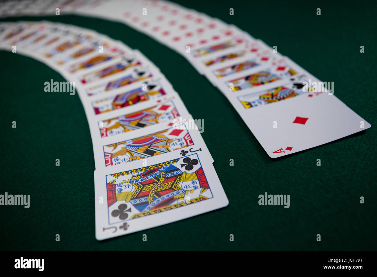 Playing cards arranged on poker table in casino Stock Photo - Alamy