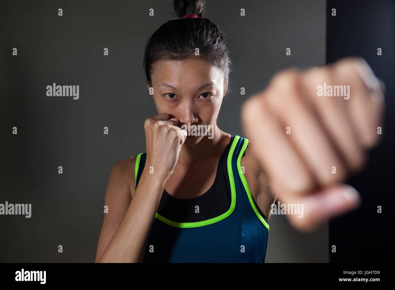 Portrait of determined woman practicing boxing in fitness studio Stock ...