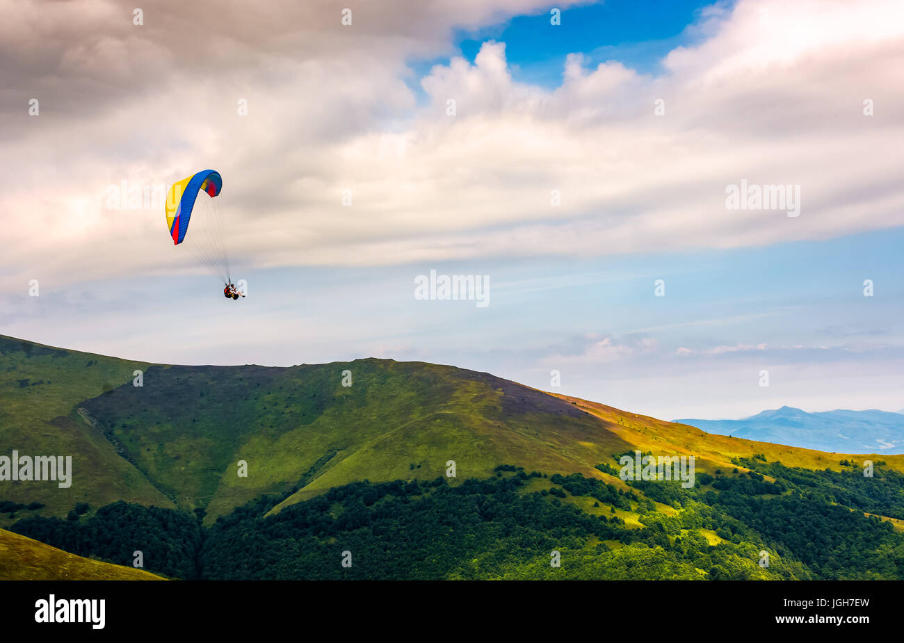 Skydiving flying in the clouds over the mountains. parachute extreme ...