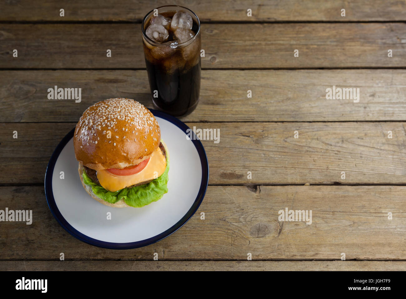 Overhead of hamburger in plate with glass of cold drink Stock Photo - Alamy