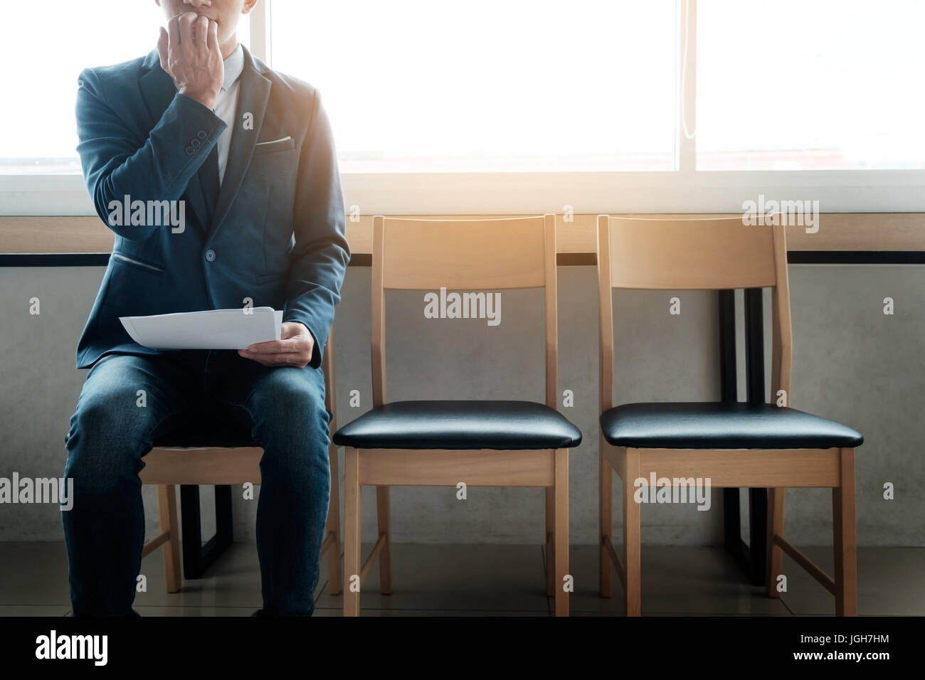 young businessman in waiting room for job interview being anxious, on a ...