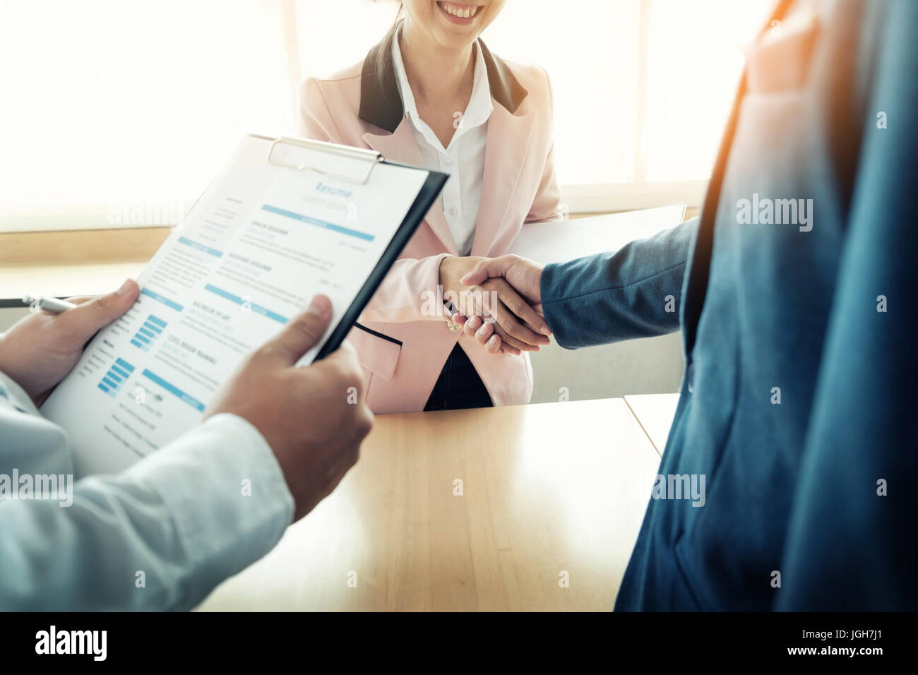 of successful business team shaking hands with eachother in the office ...