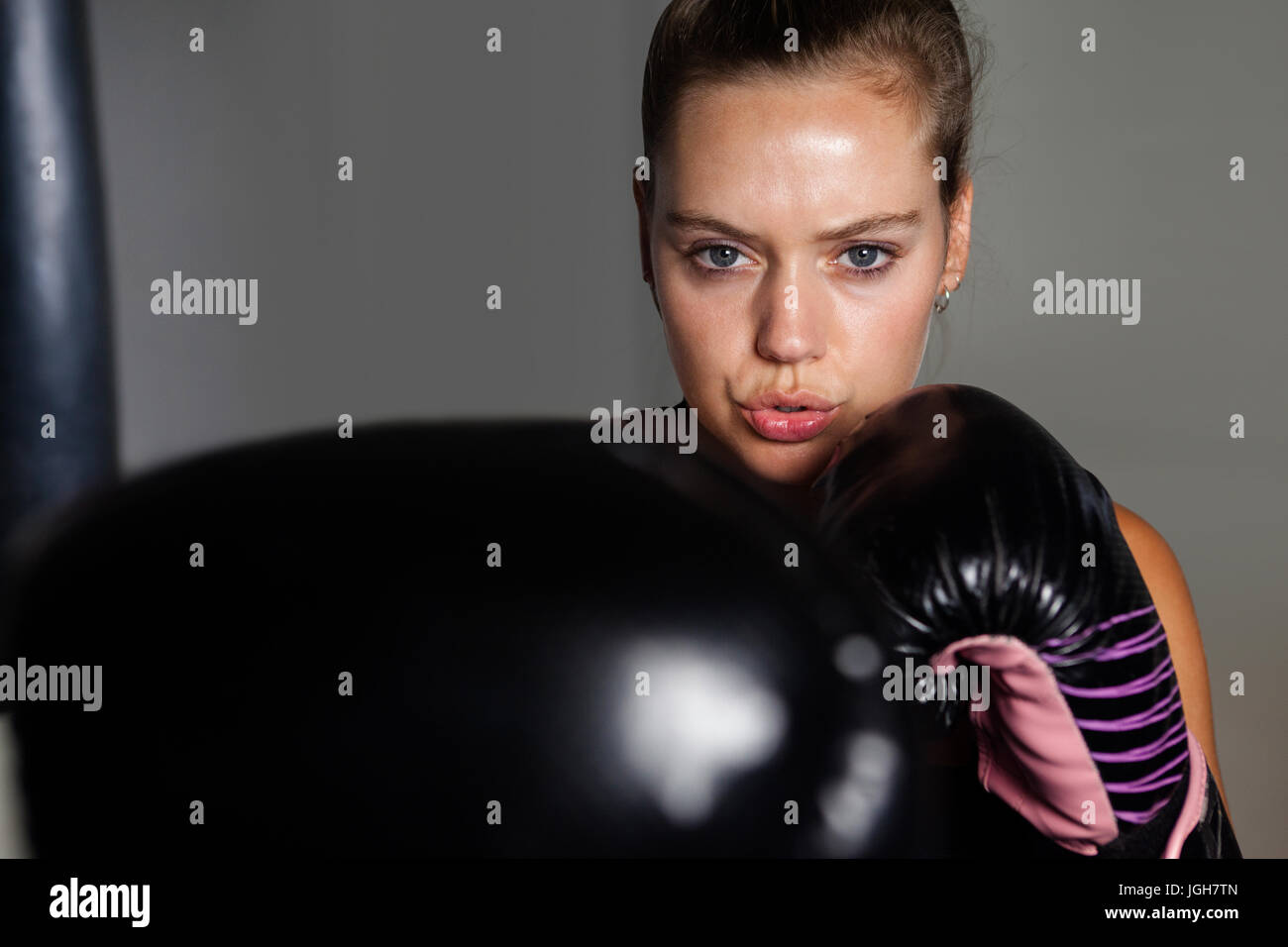 Beautiful woman practicing boxing in fitness studio Stock Photo - Alamy