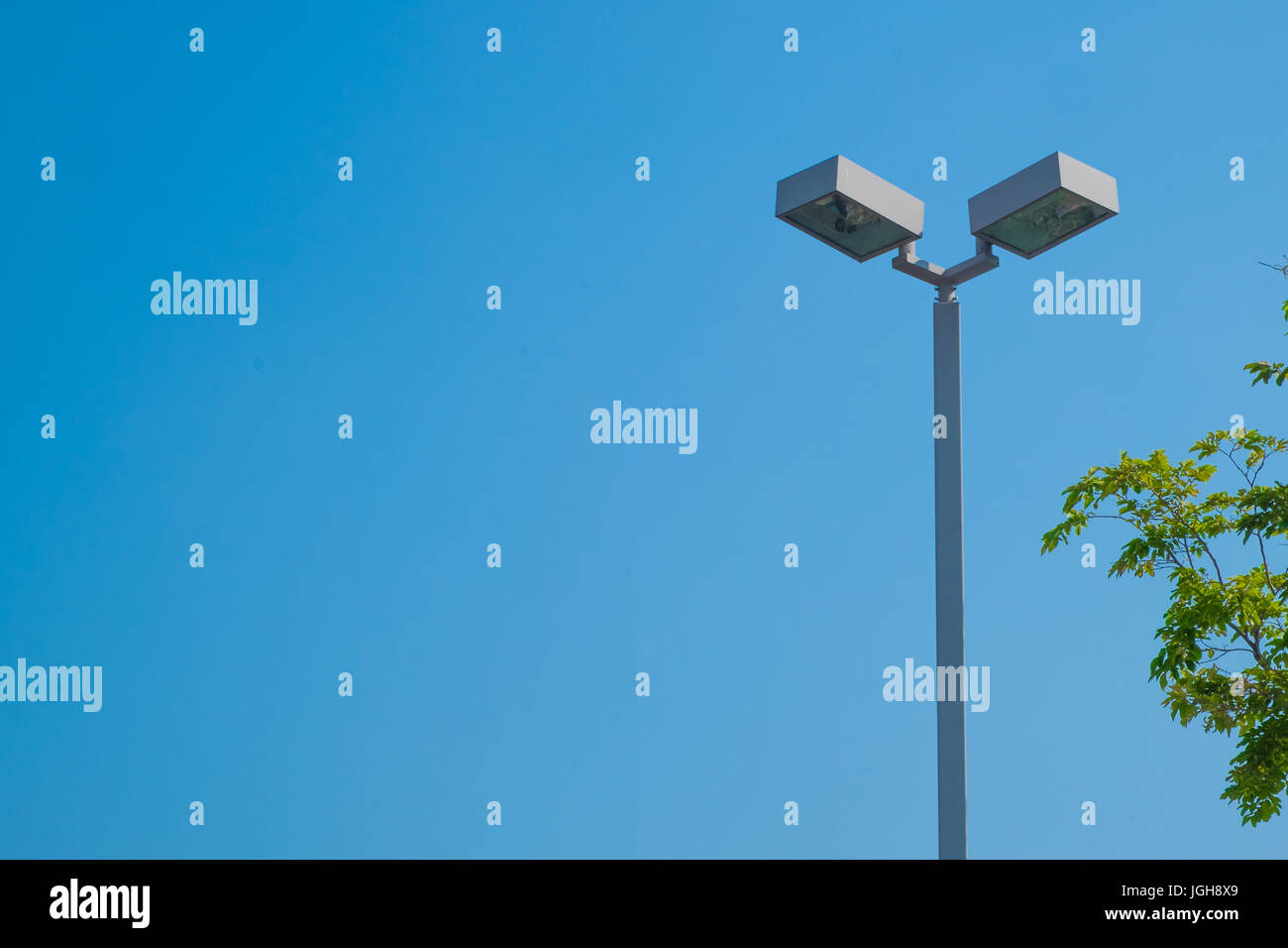 Lamp post electricity industry with blue sky background and tree ...