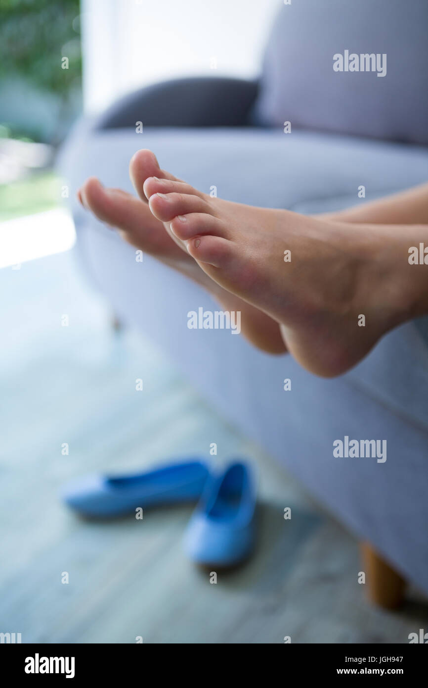 Close up of girl legs sitting on sofa at home Stock Photo - Alamy