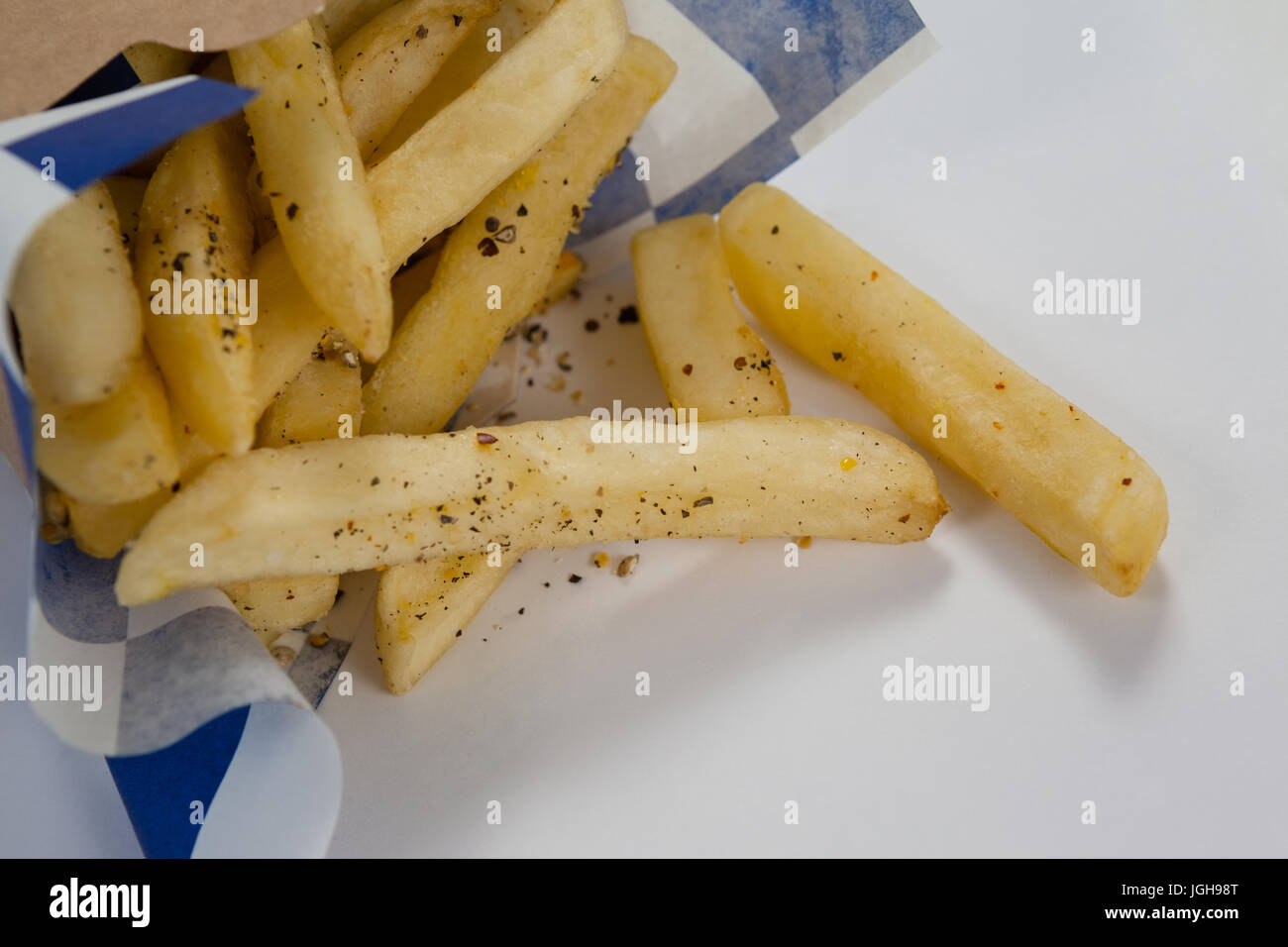Close-up of french fried chips in a take away container on table Stock ...