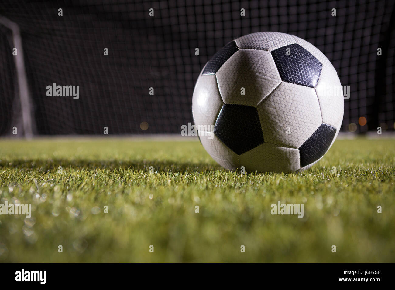 Close-up of soccer ball on playing field against goal post Stock Photo ...