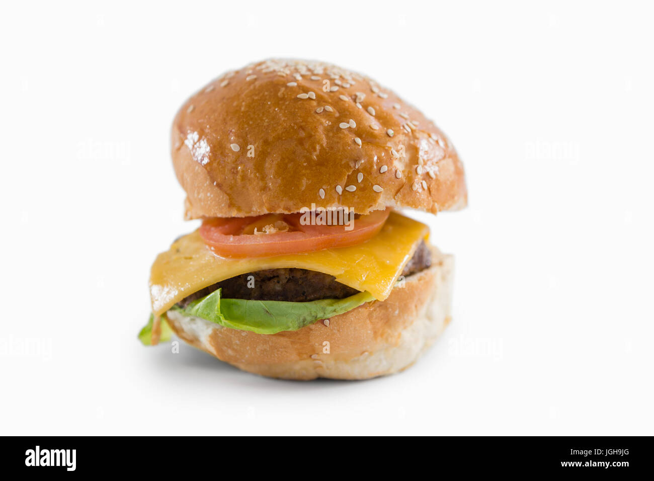 Close up of cheeseburger with sesame seeds against white background ...