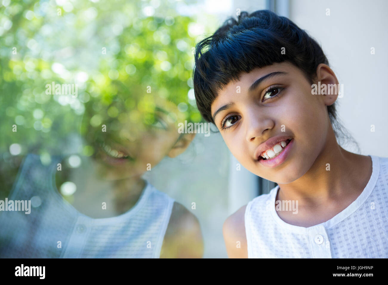 Girl sitting at window seat hi-res stock photography and images - Alamy