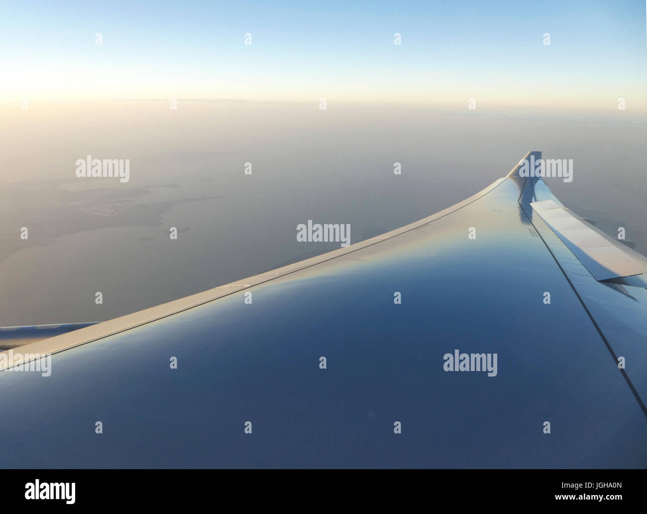View of airplane wing through window Stock Photo - Alamy