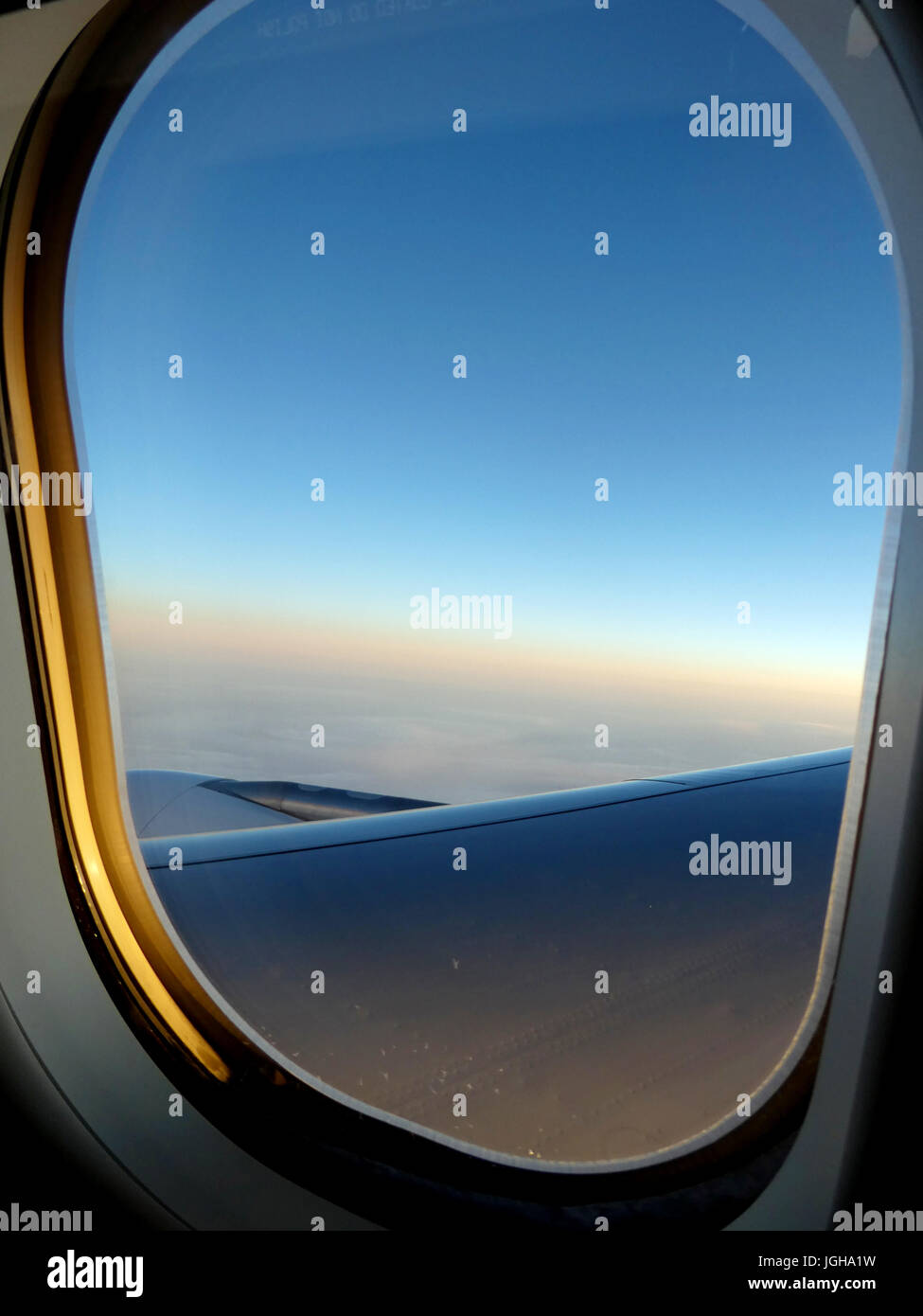 Dawn seen through airplane window Stock Photo - Alamy