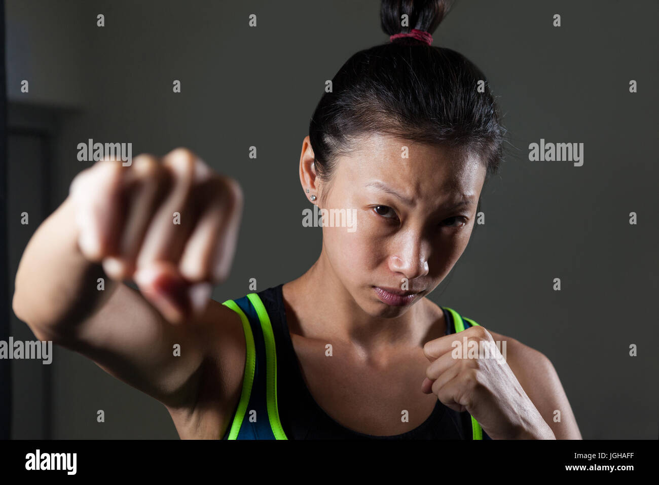 Determined woman practicing boxing in fitness studio Stock Photo - Alamy