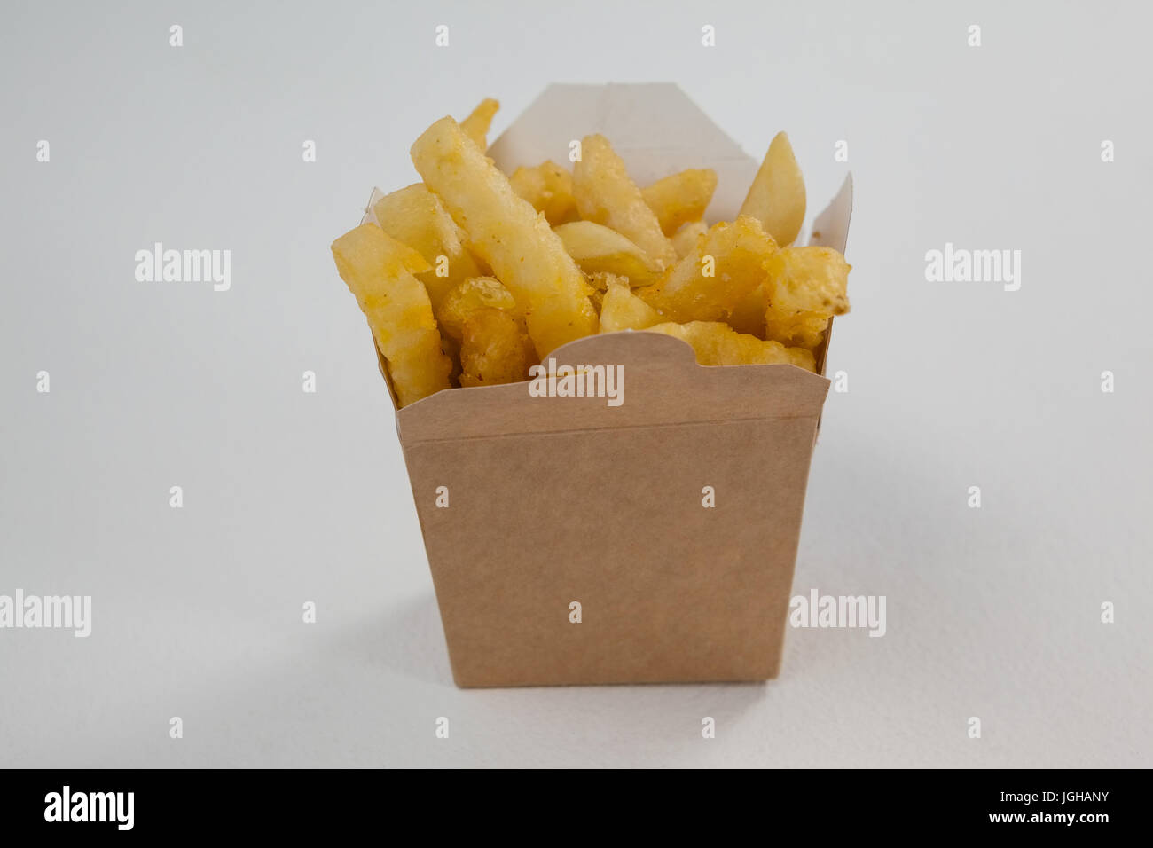 Close-up of french fried chips in a take away container on table Stock ...