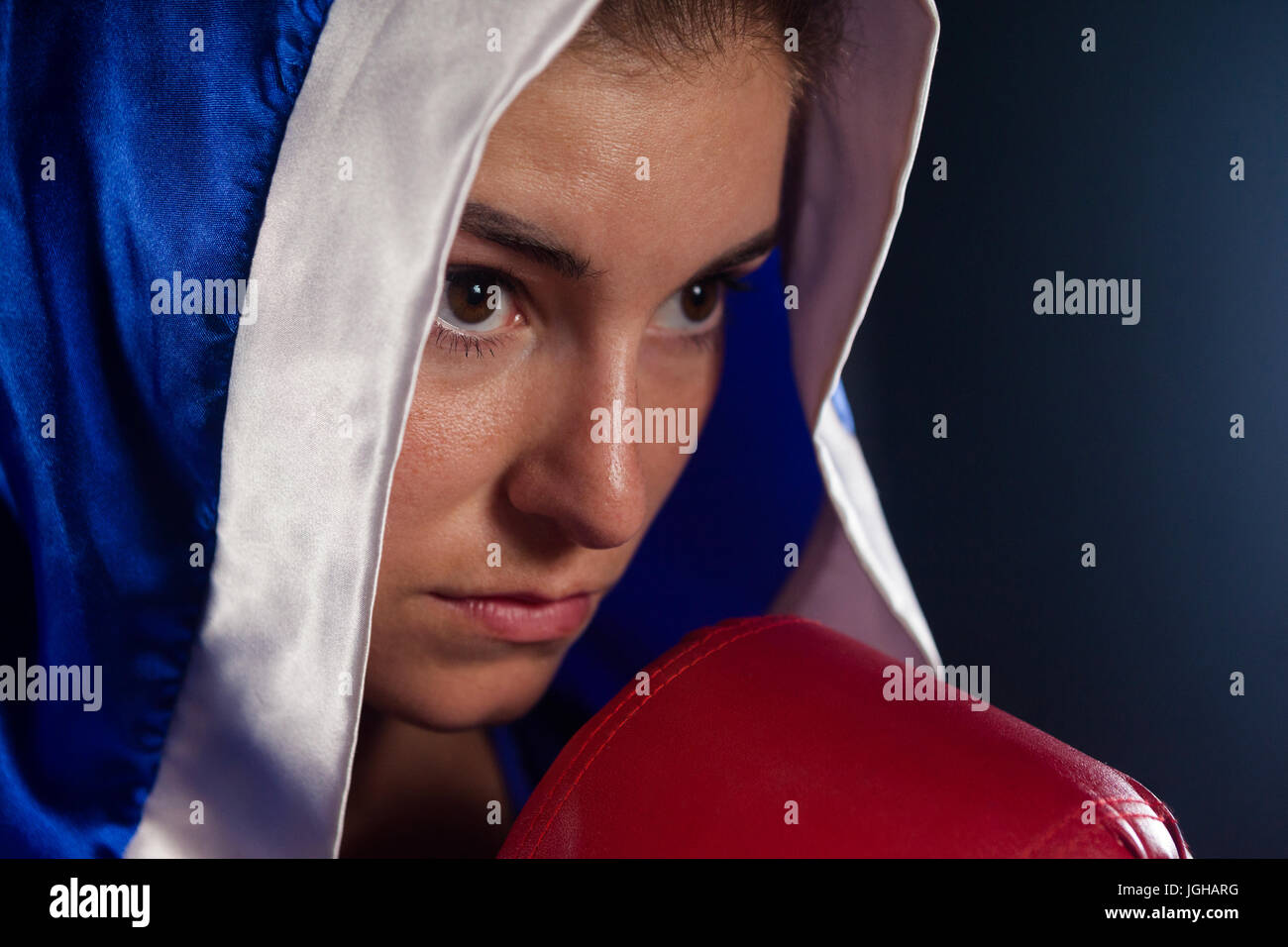 Determined woman wearing boxing robe in fitness studio Stock Photo - Alamy