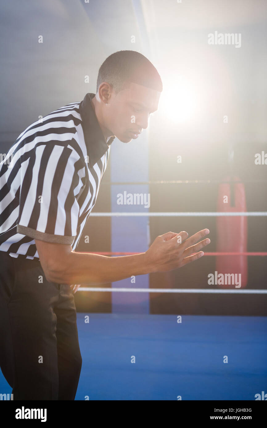 Young male referee gesturing in boxing ring at fitness studio Stock ...
