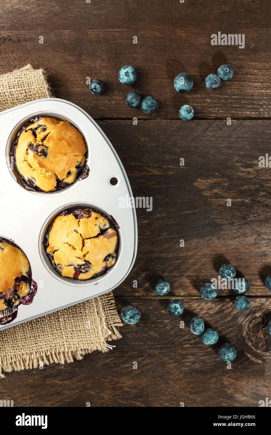 An overhead photo of freshly baked homemade muffins in a pan, with ...