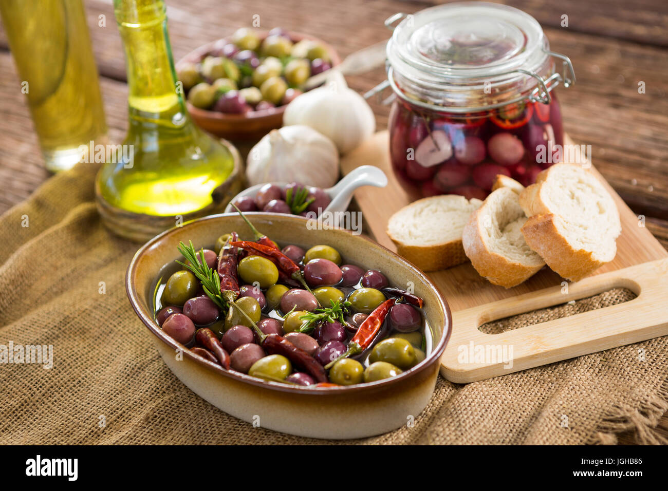 Marinated olives with ingredient and breakfast on wooden table Stock ...