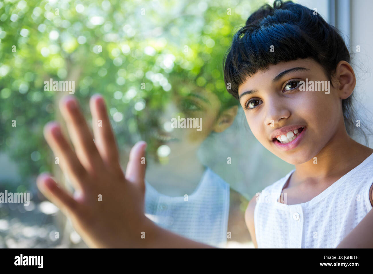 Girl standing window home childhood hi-res stock photography and images ...