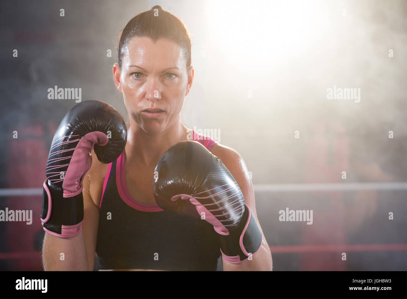 Portrait of confident young female boxer in fitness studio Stock Photo ...