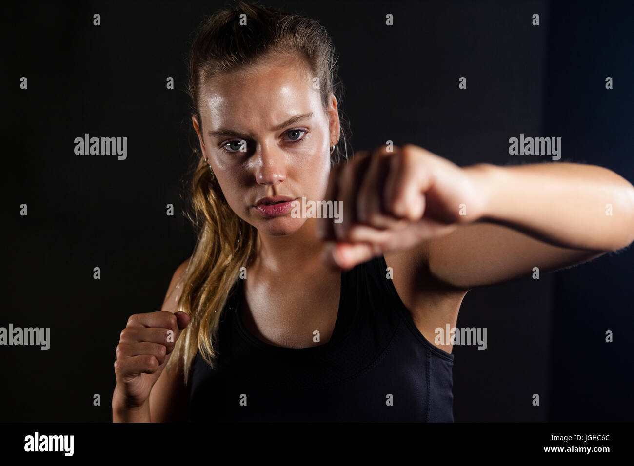 Determined woman practicing boxing in fitness studio Stock Photo - Alamy