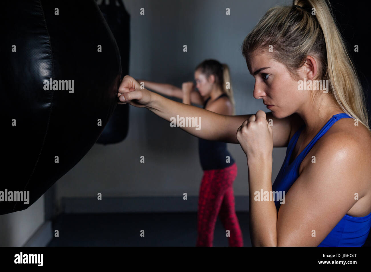 Determined women practicing boxing in fitness studio Stock Photo - Alamy