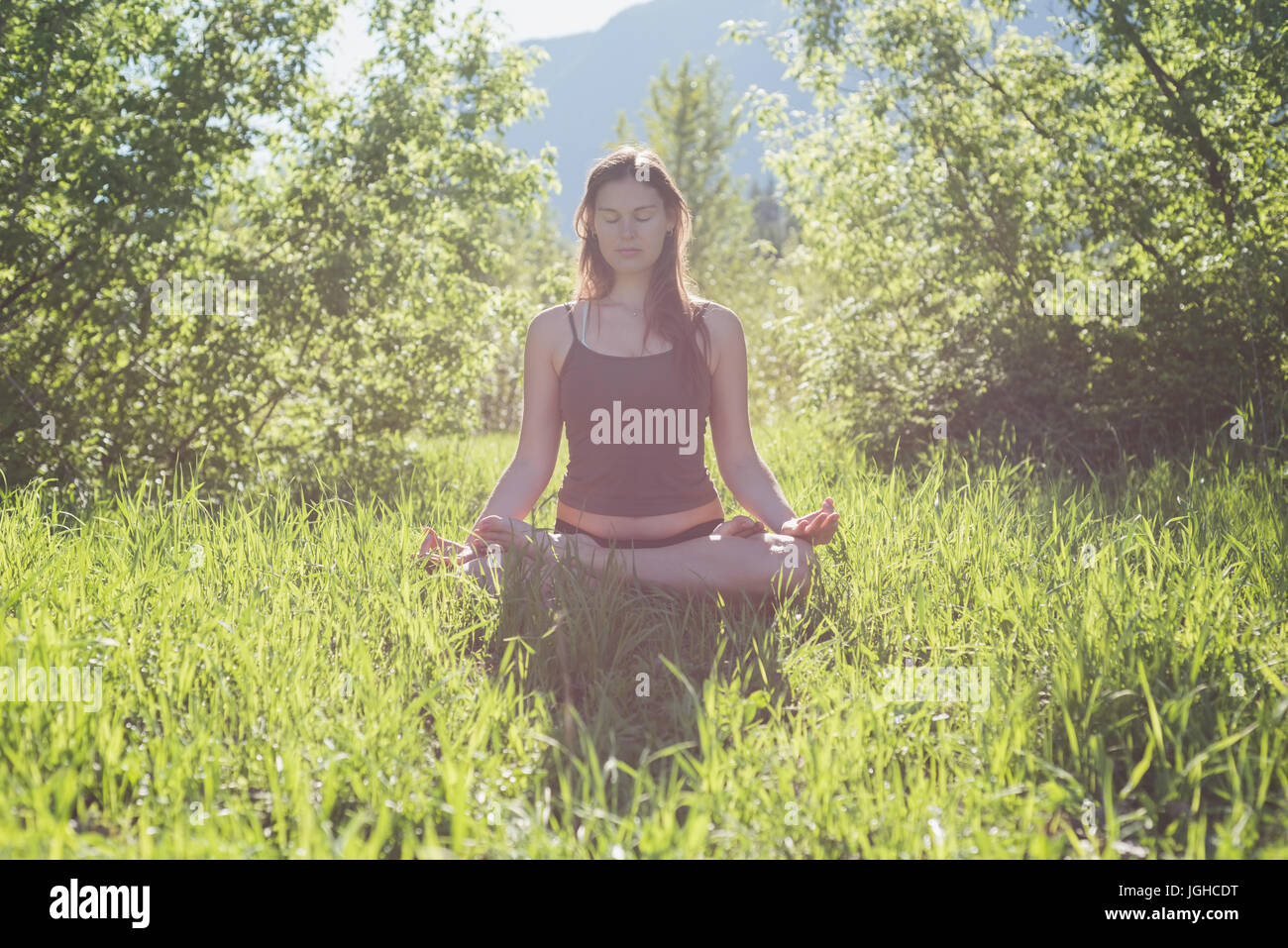 Woman meditating in beautiful environment hi-res stock photography and ...