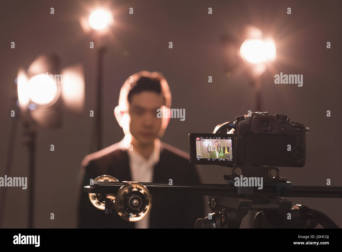 Close-up of video camera photographing male model in studio Stock Photo ...
