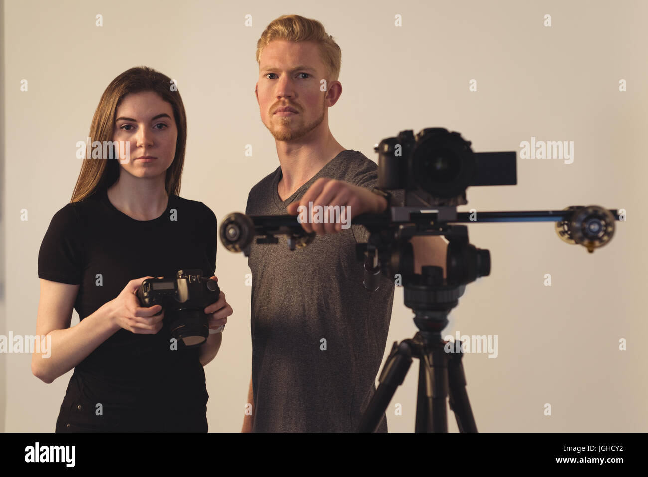 Portrait of photographer with assistant standing at studio Stock Photo ...