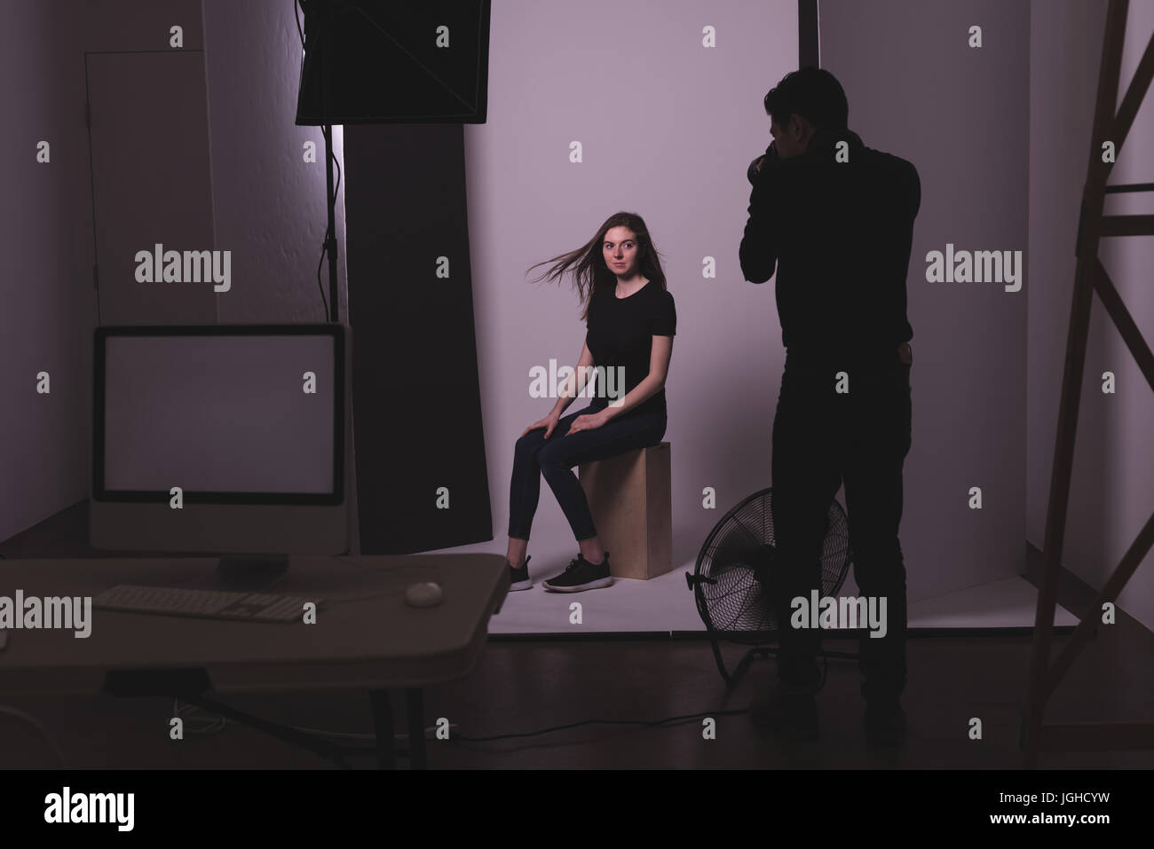 Rear view full length of photographer photographing female model at ...