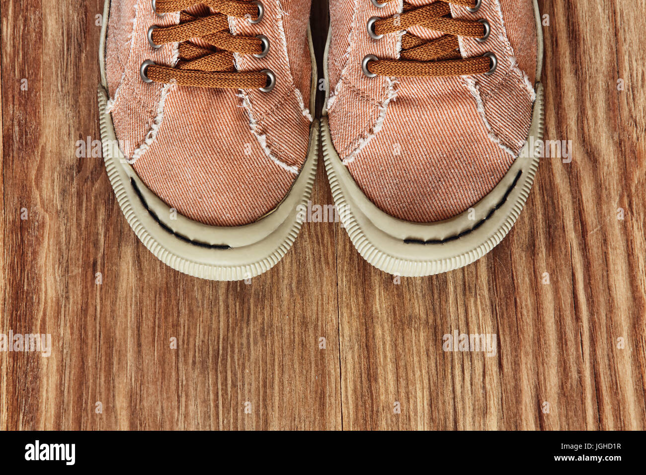 Front part of Gym shoes on grunge wooden background.Top view and toned ...
