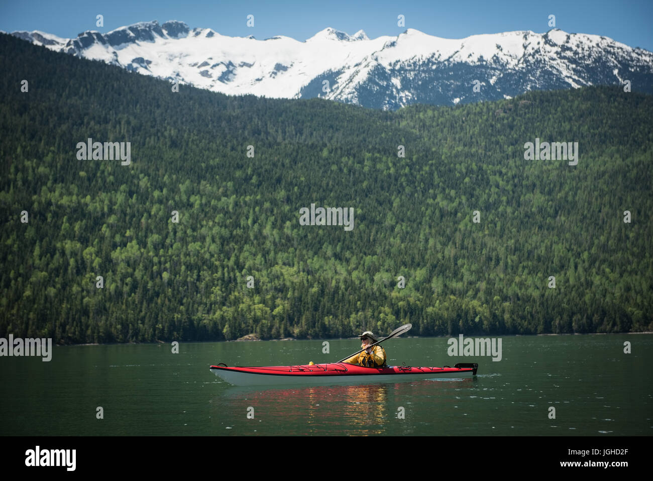 Side view of man kayaking in lake against mountain Stock Photo - Alamy