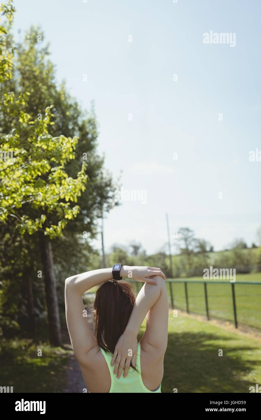 Rear view of woman stretching hi-res stock photography and images - Alamy