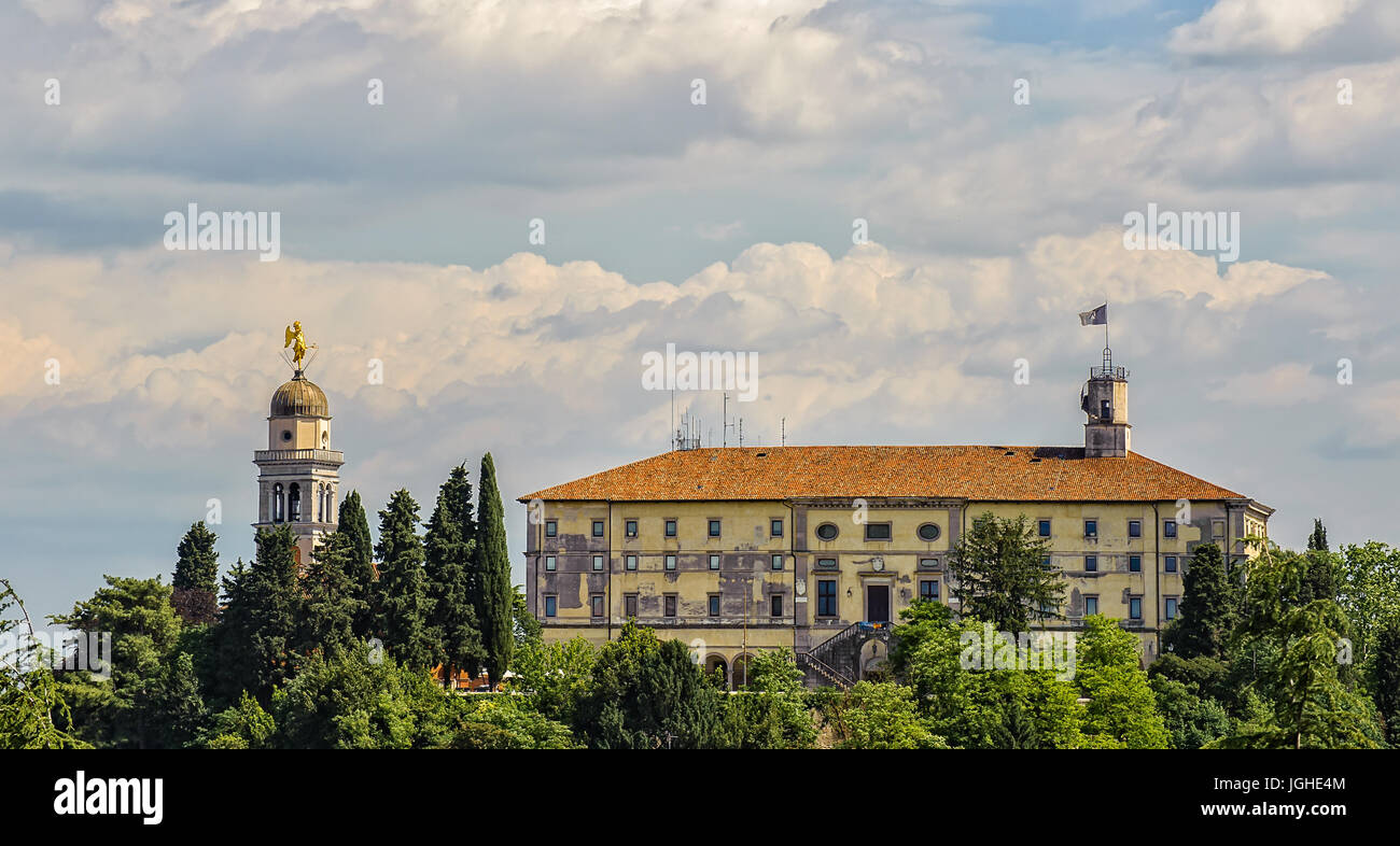 View from castle of Udine, belfry with golden angel and cloudy sky ...