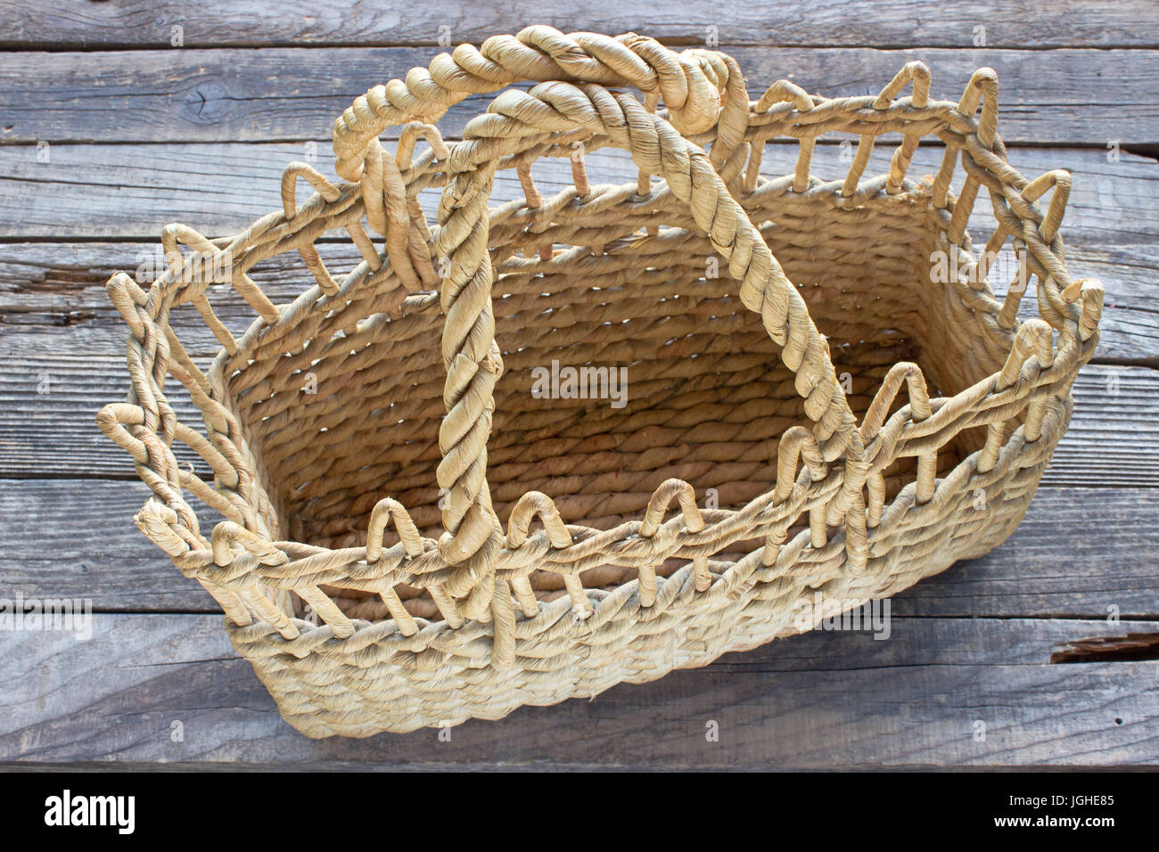 Straw shopping basket on wooden background Stock Photo - Alamy
