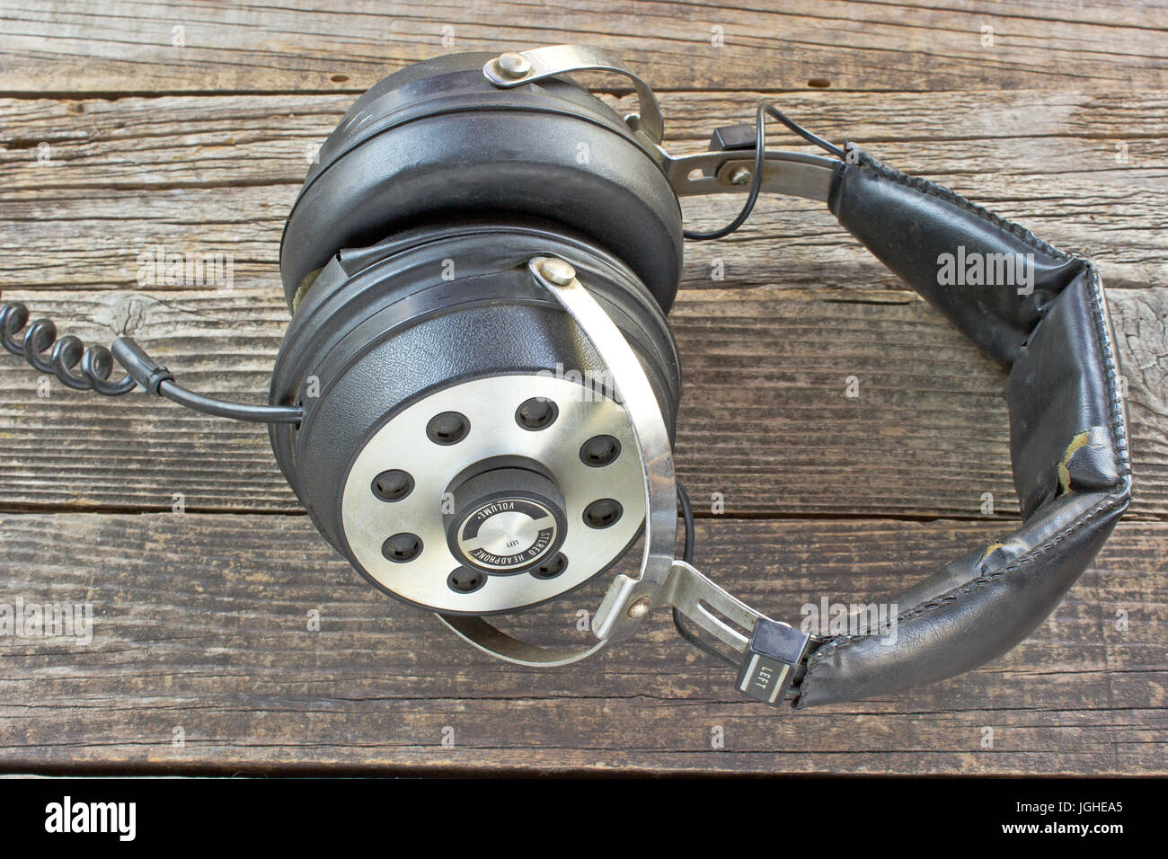 Old stereo headphones on wooden background Stock Photo - Alamy