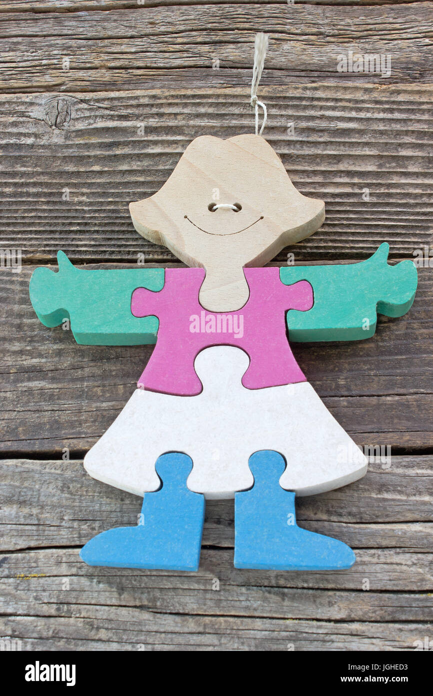 Colorful wooden girl puzzle pieces on board Stock Photo - Alamy