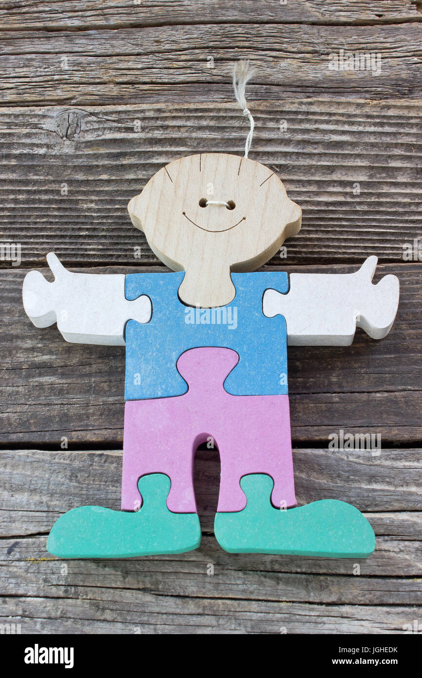 Colorful wooden boy puzzle pieces on board Stock Photo - Alamy