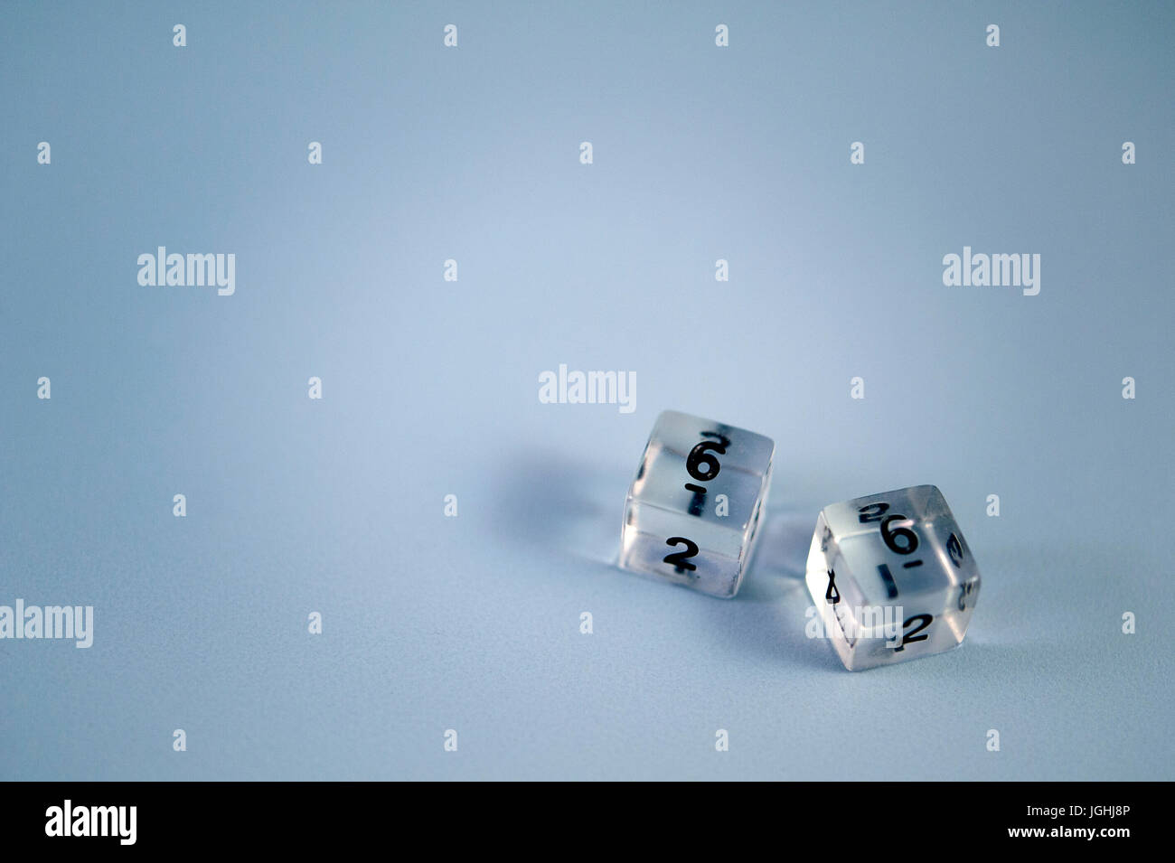 still life with plastic dice on light blue background Stock Photo - Alamy