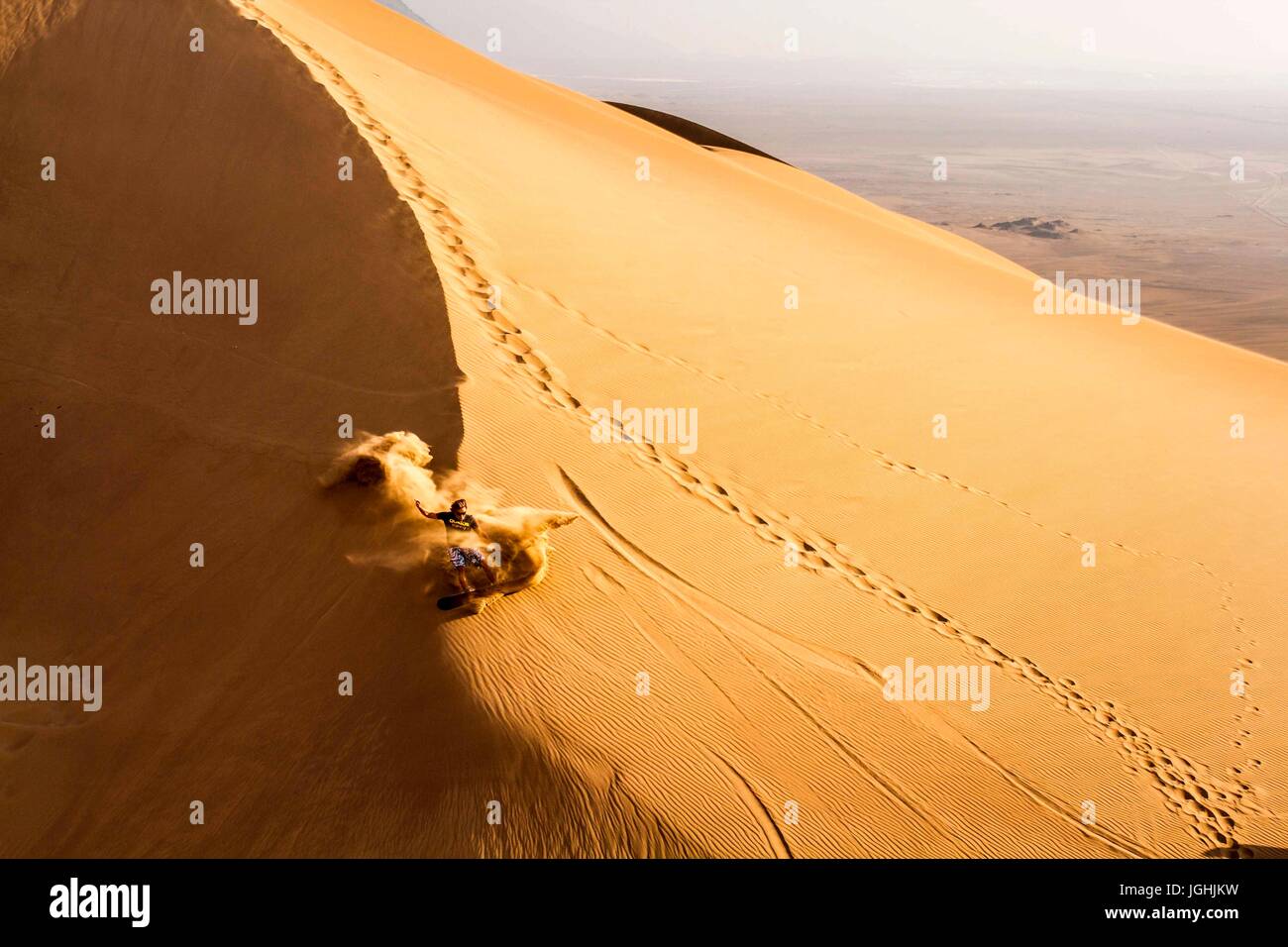 Sandboarding on Caramucho dunes, in Atacama Desert. Iquique, Tarapaca ...