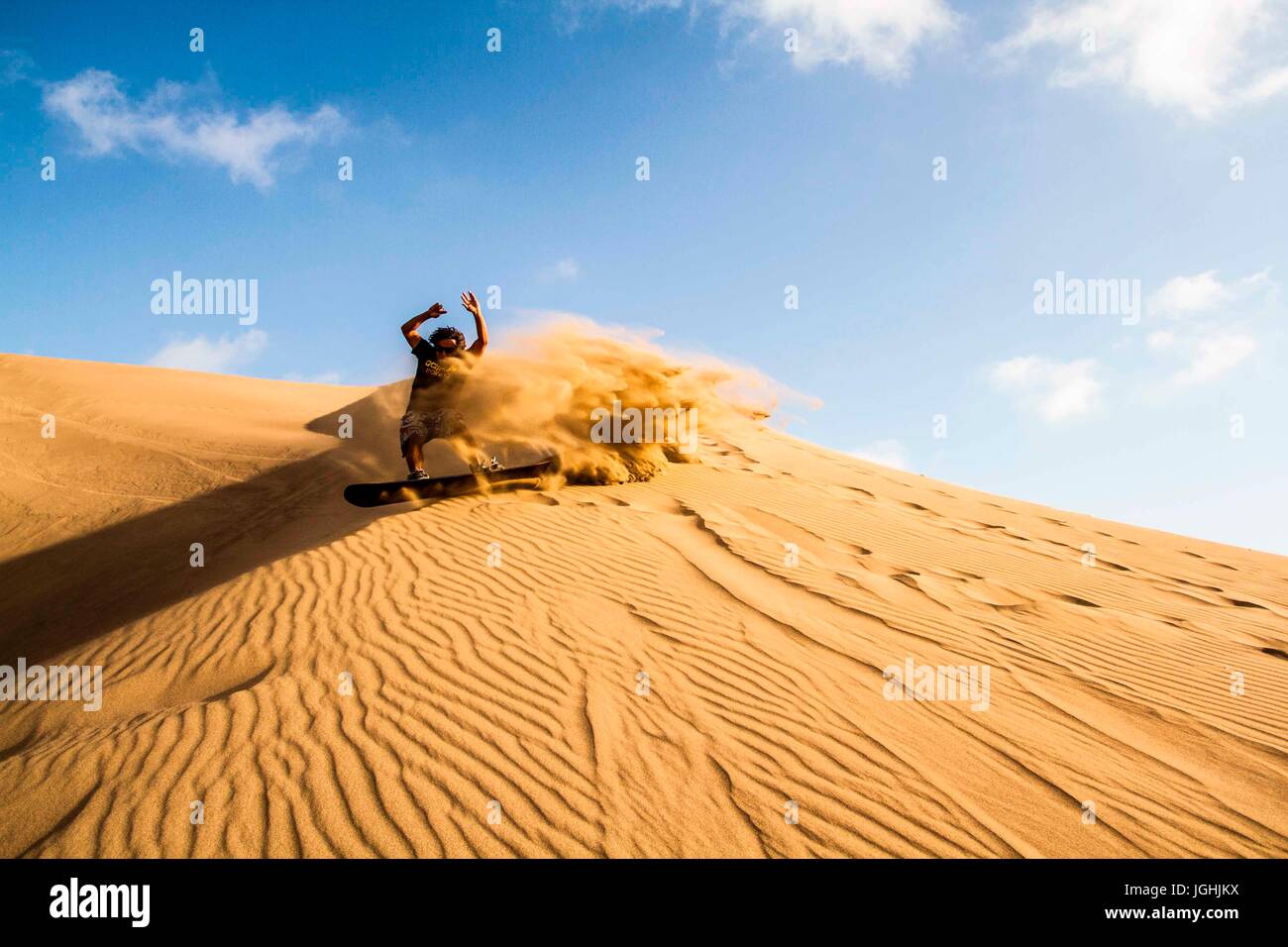 Sandboarding on Caramucho dunes, in Atacama Desert. Iquique, Tarapaca ...