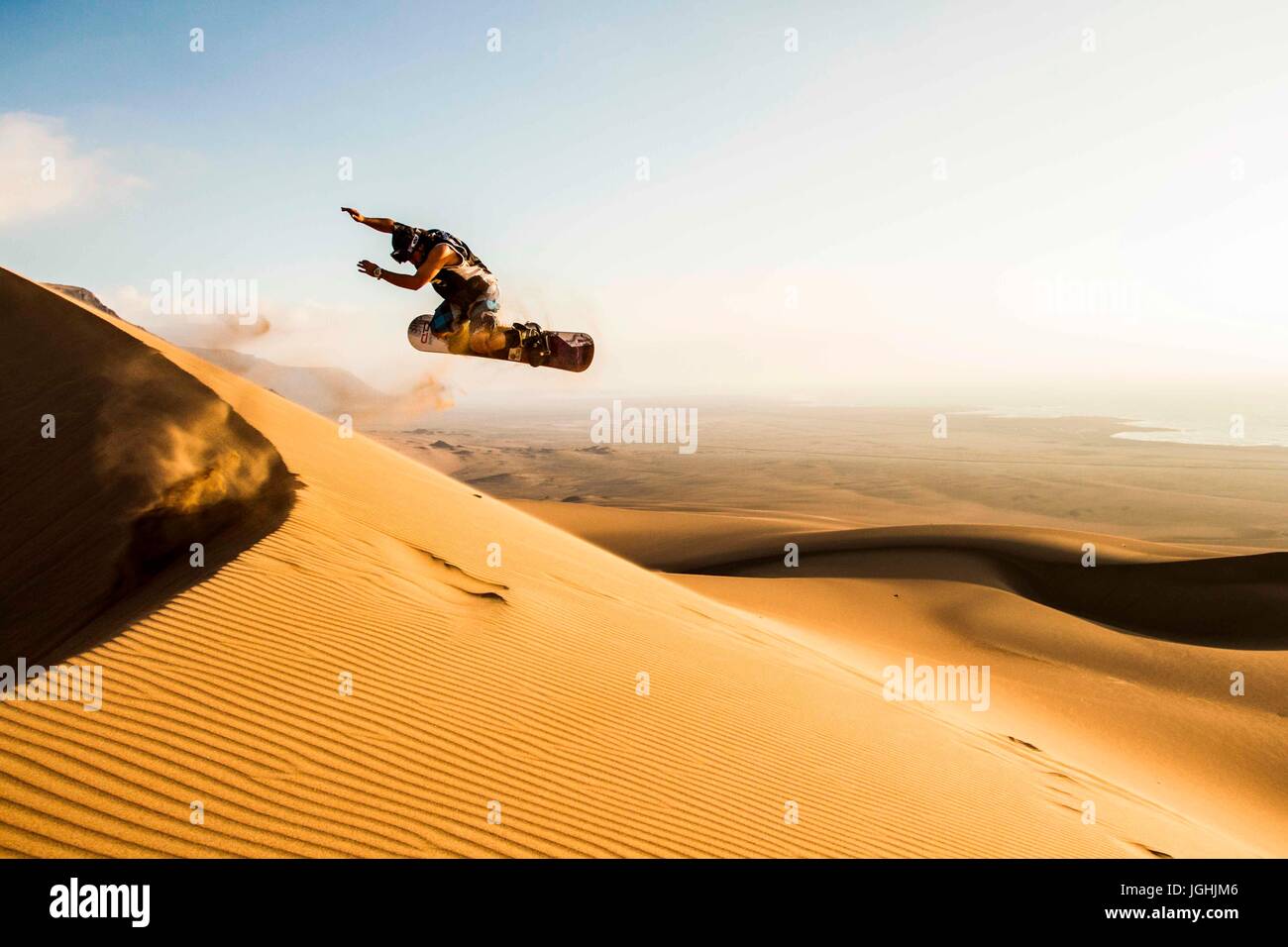 Sandboarding on Caramucho dunes, in Atacama Desert. Iquique, Tarapaca ...