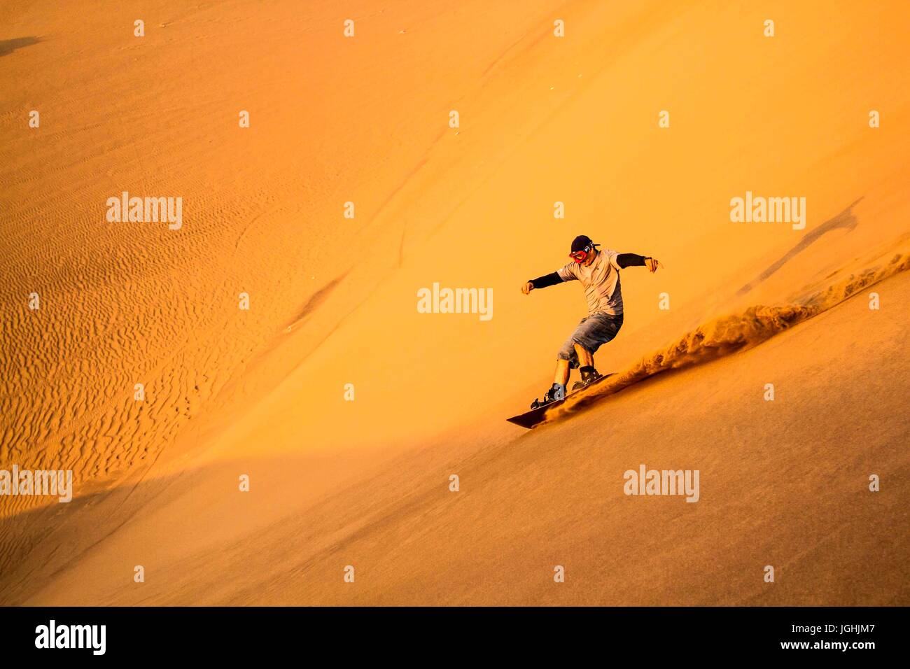 Sandboarding on Caramucho dunes, in Atacama Desert. Iquique, Tarapaca ...