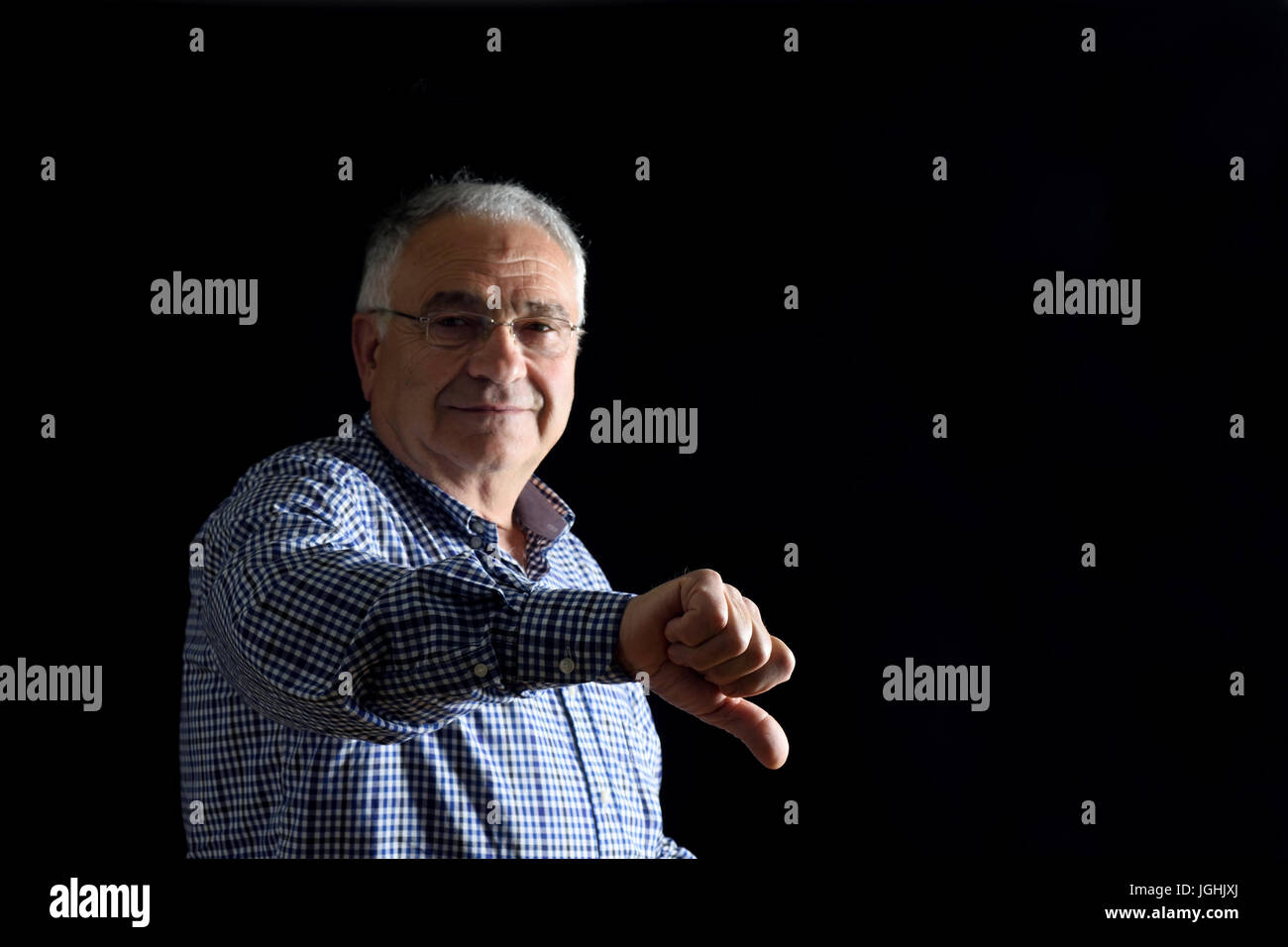 Senior Man with thumb down Stock Photo - Alamy